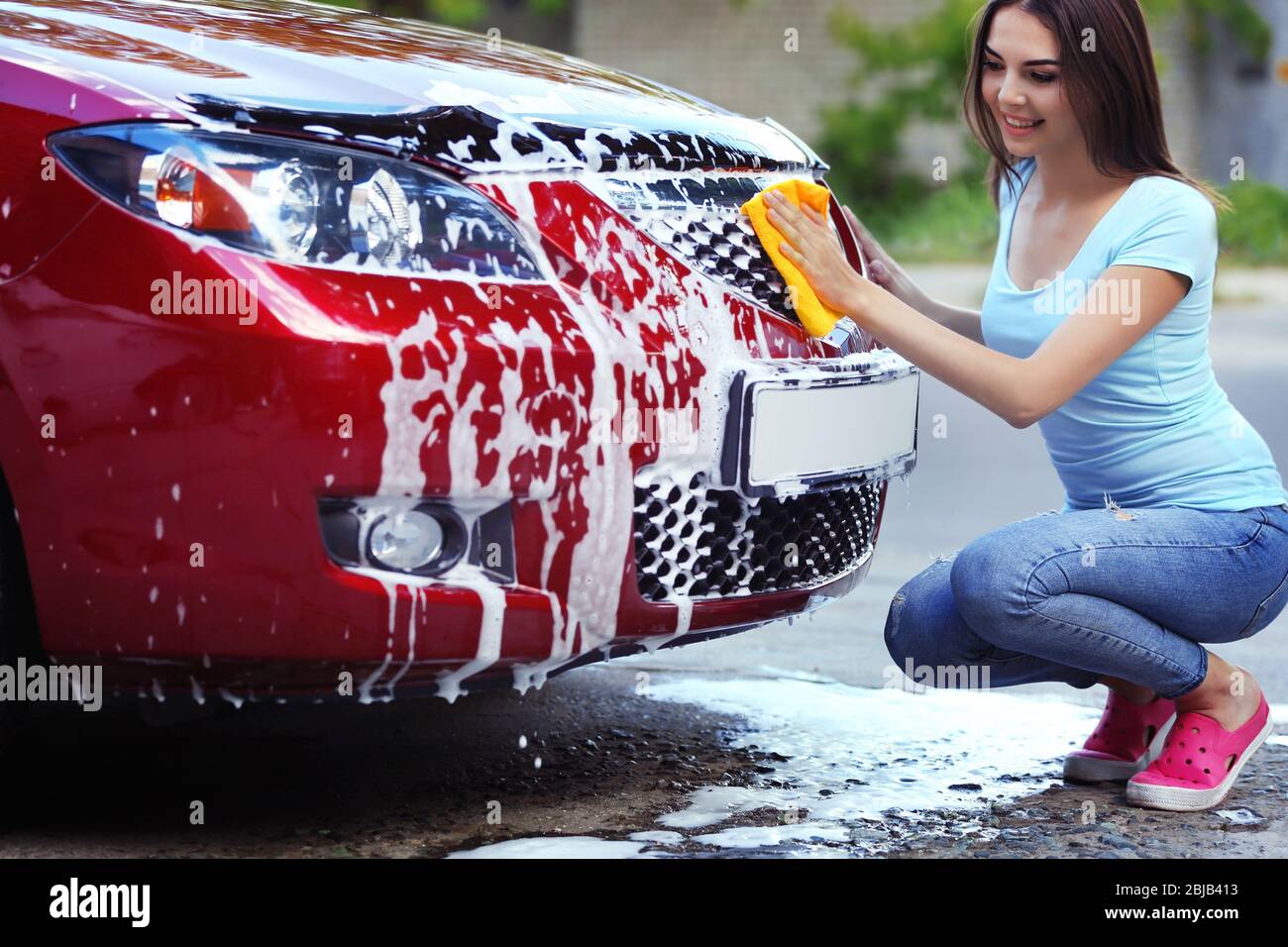 Woman washing a car Stock Photo - Alamy