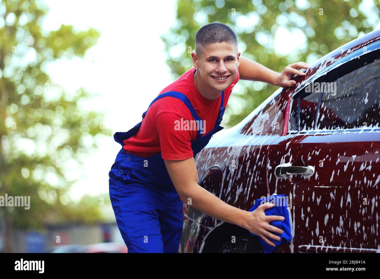 Serviceman washing a car Stock Photo - Alamy