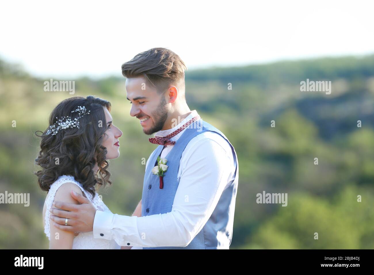Bride and groom standing over beautiful landscape Stock Photo - Alamy