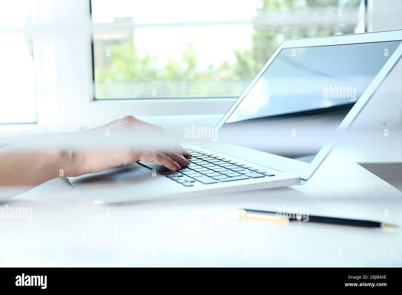 Woman hands working on computer at desk Stock Photo - Alamy