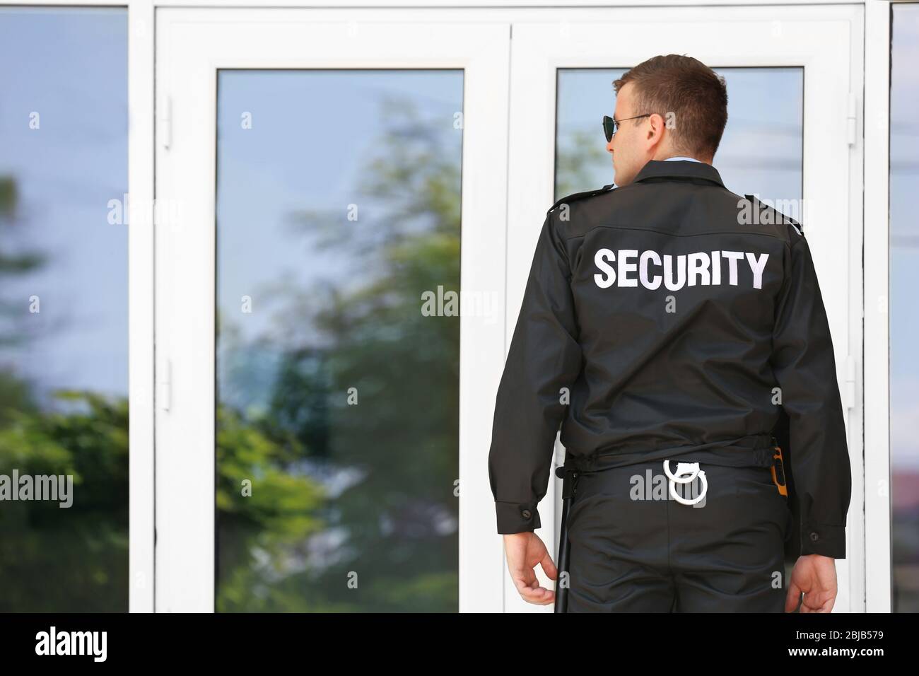 Male security guard outdoors Stock Photo - Alamy