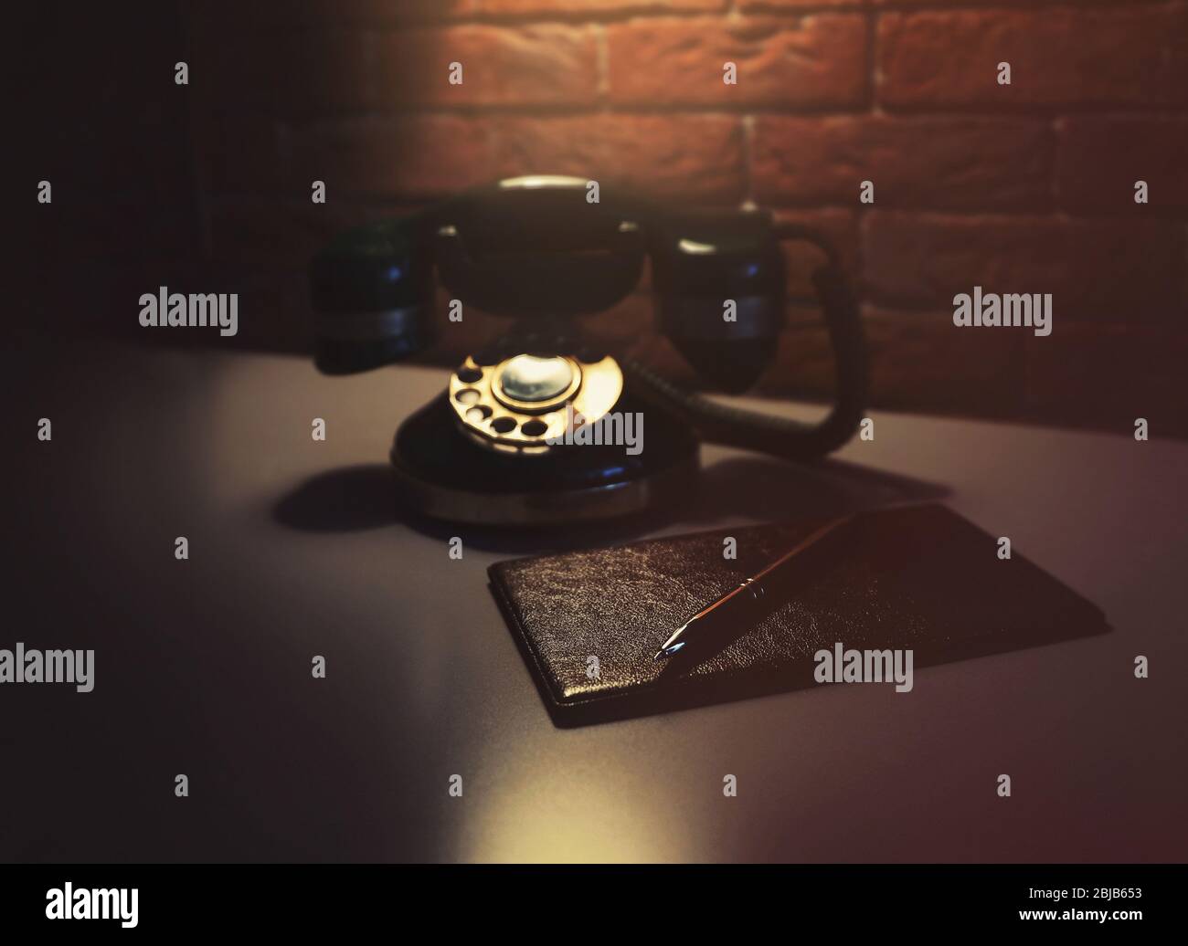 Old telephone on the table in dark room Stock Photo - Alamy