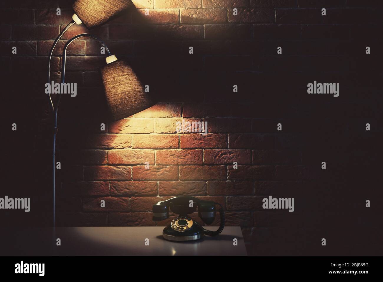 Old telephone on the table in dark room Stock Photo - Alamy