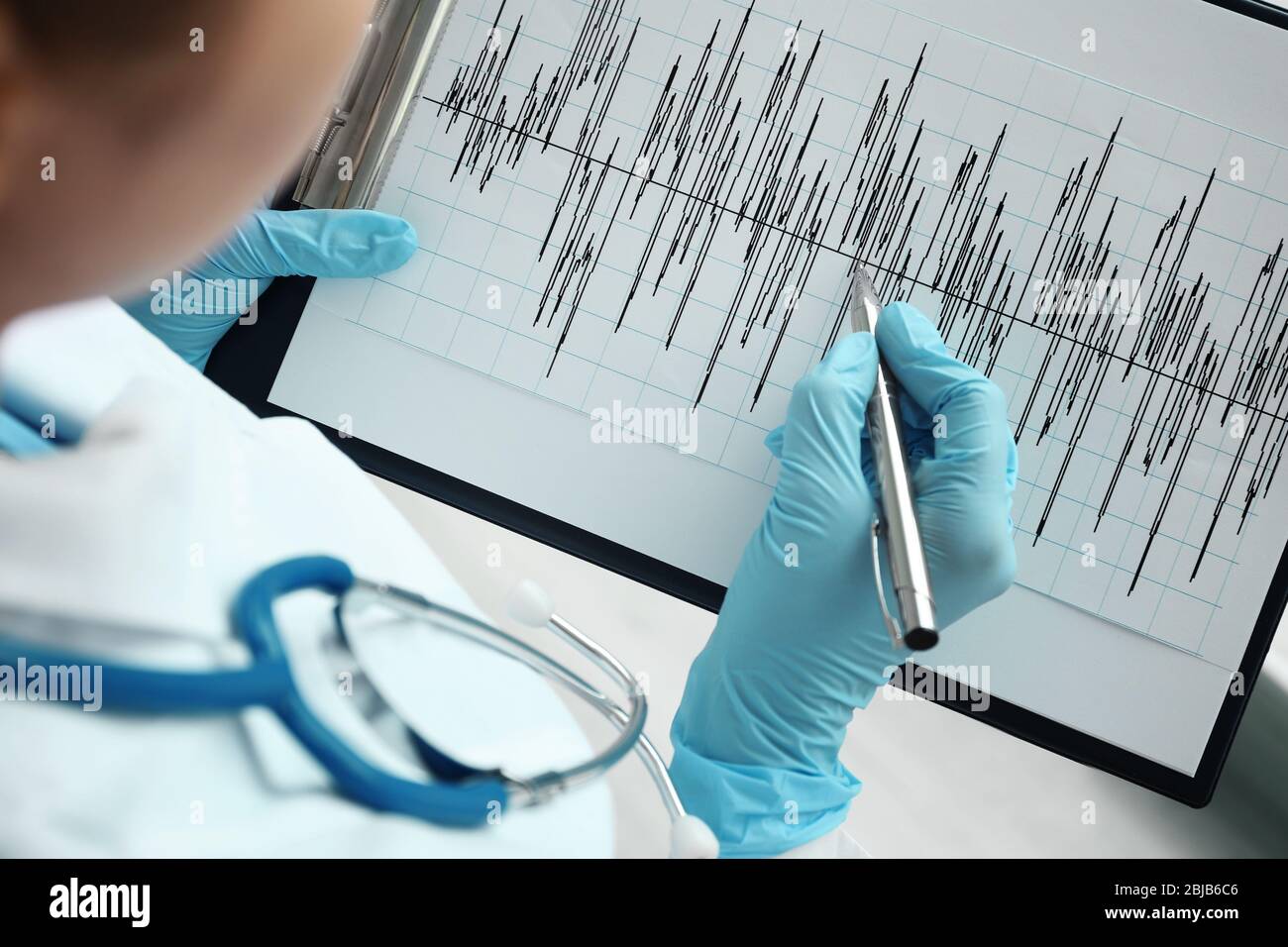 Cardiologist with stethoscope holding cardiogram in hospital Stock ...