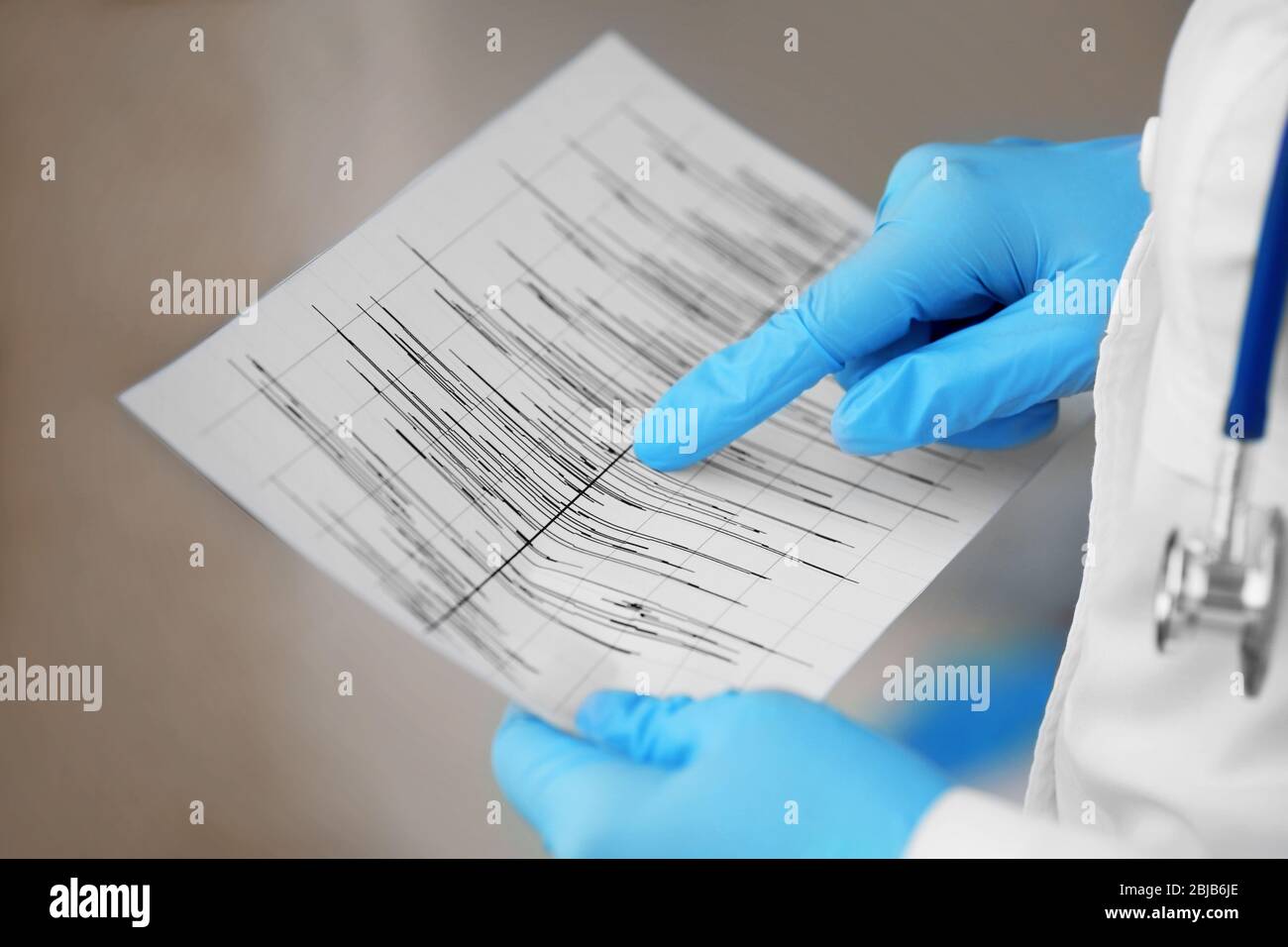 Cardiologist with stethoscope holding cardiogram in hospital Stock ...