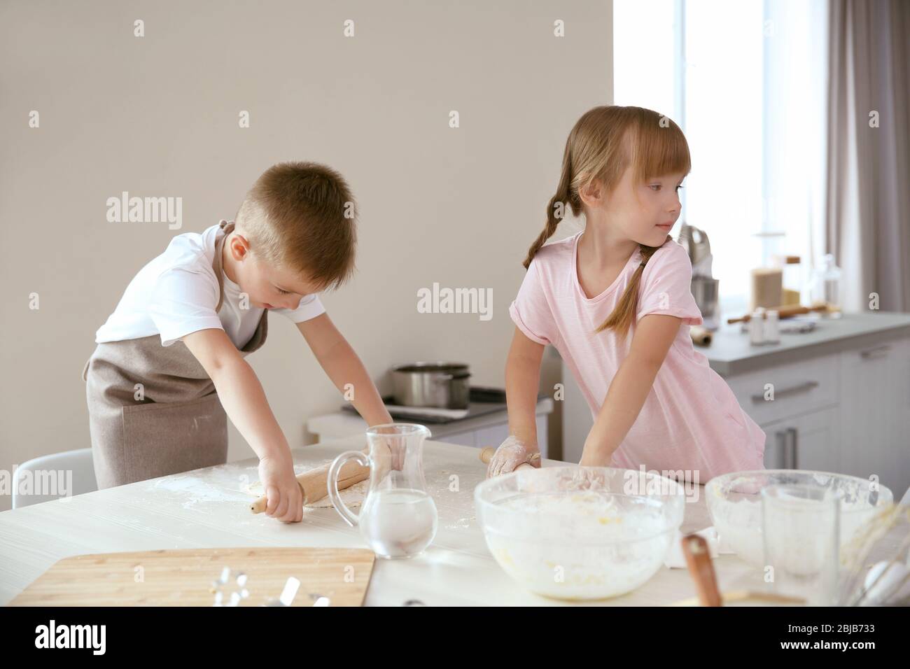 Kids making biscuits in kitchen Stock Photo - Alamy