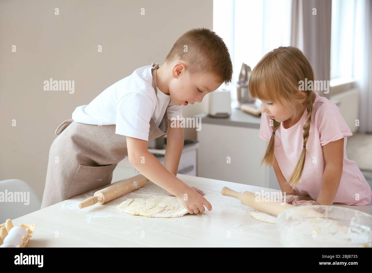 Kids making biscuits in kitchen Stock Photo - Alamy