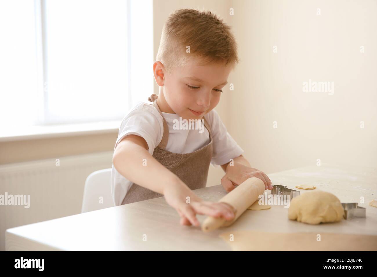 Little boy making biscuits Stock Photo - Alamy