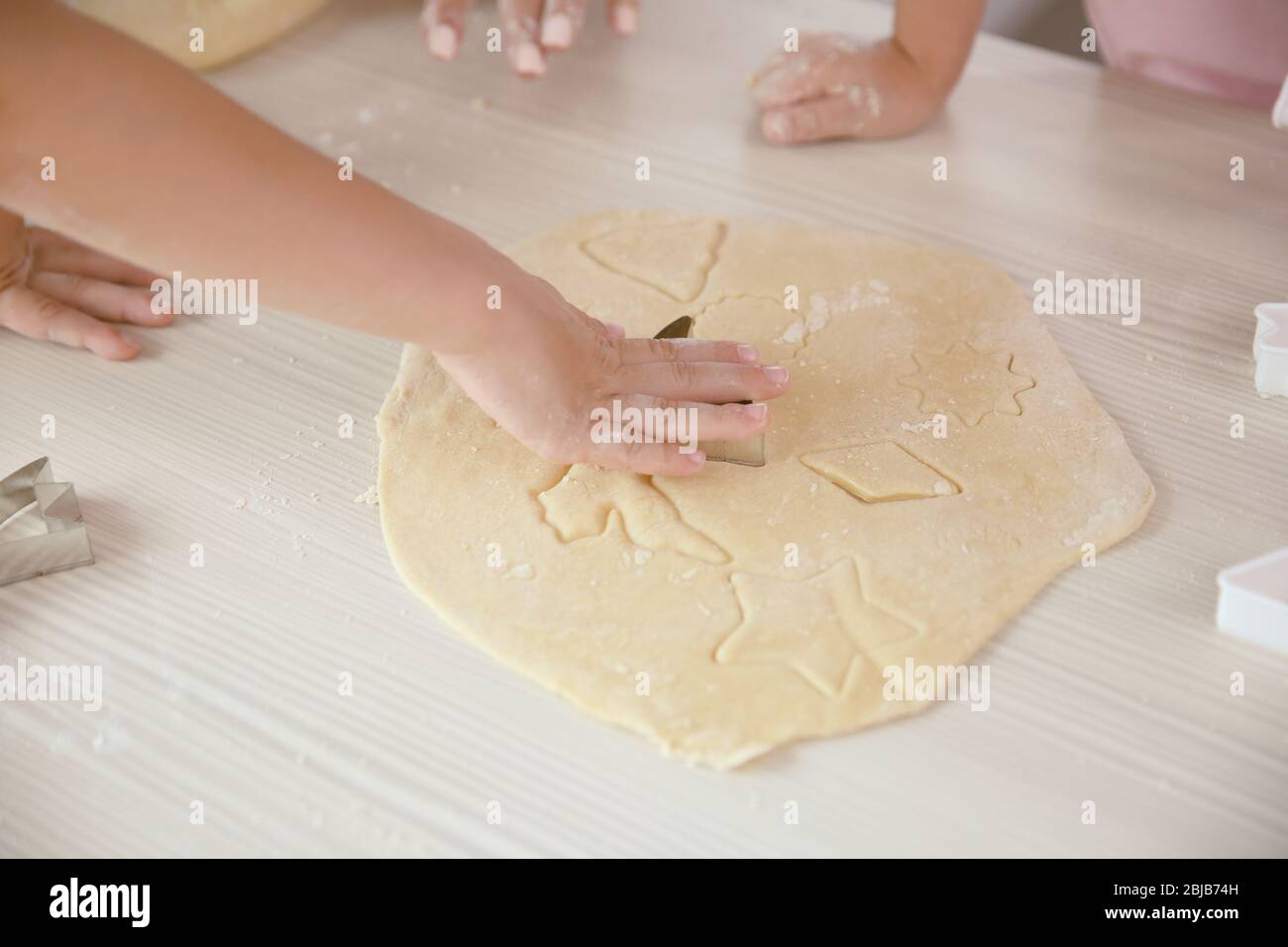 Kids hands making biscuits on table, closeup Stock Photo - Alamy