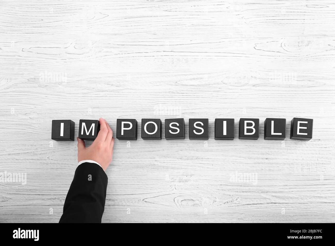 Human hand turning word impossible into possible Stock Photo - Alamy