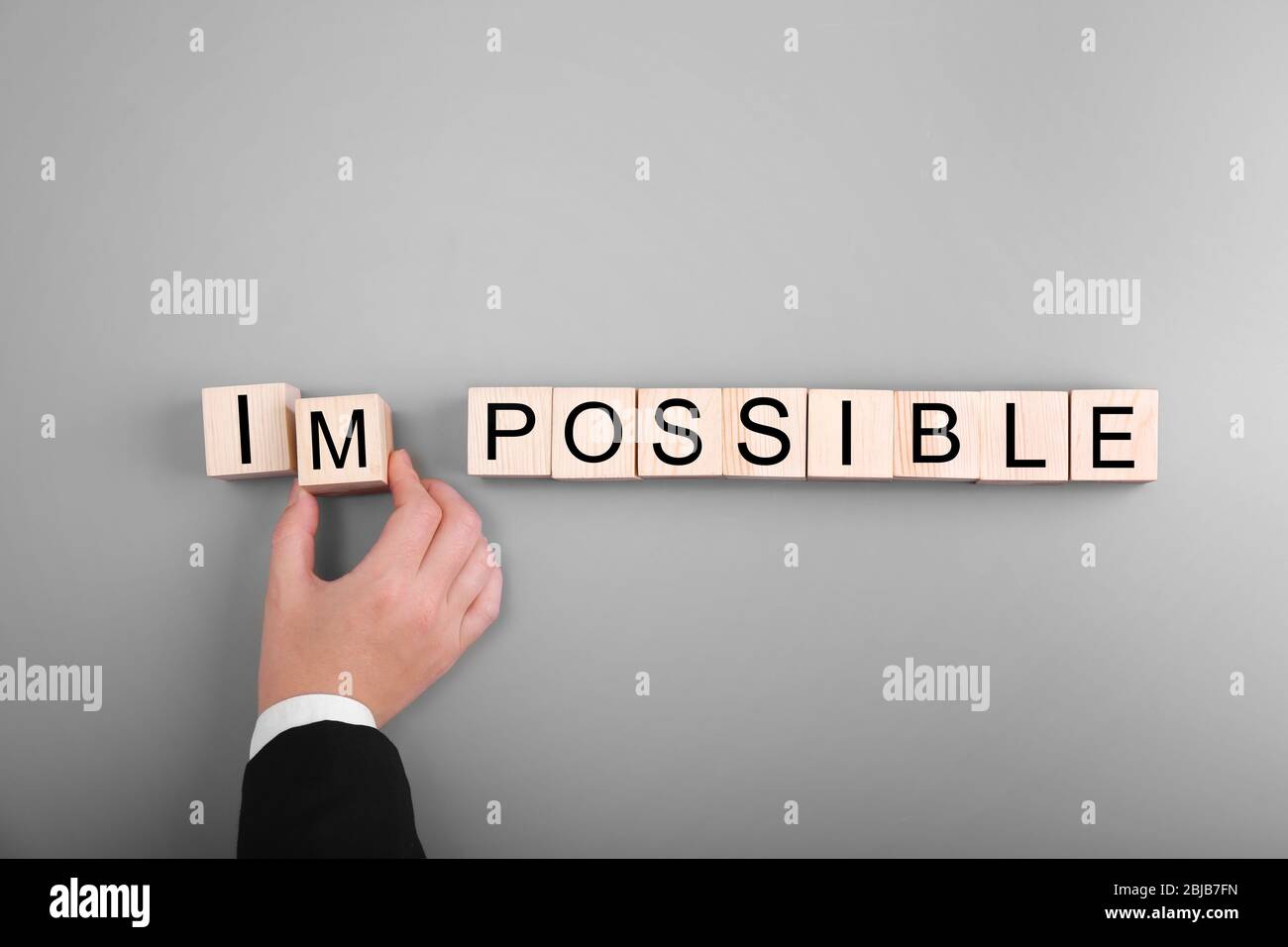 Human hand turning word impossible into possible Stock Photo - Alamy