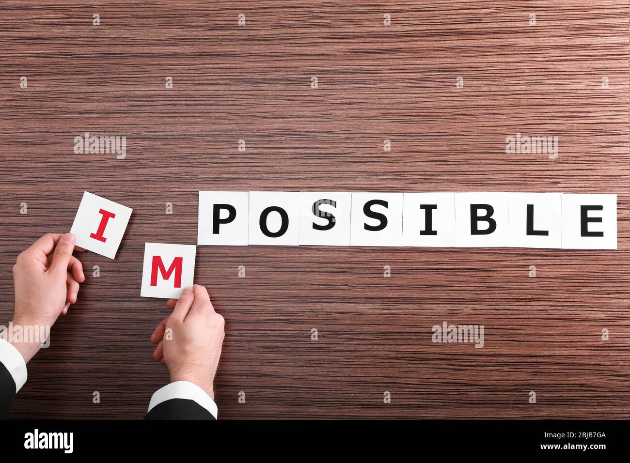 Human hands turning word impossible into possible Stock Photo - Alamy