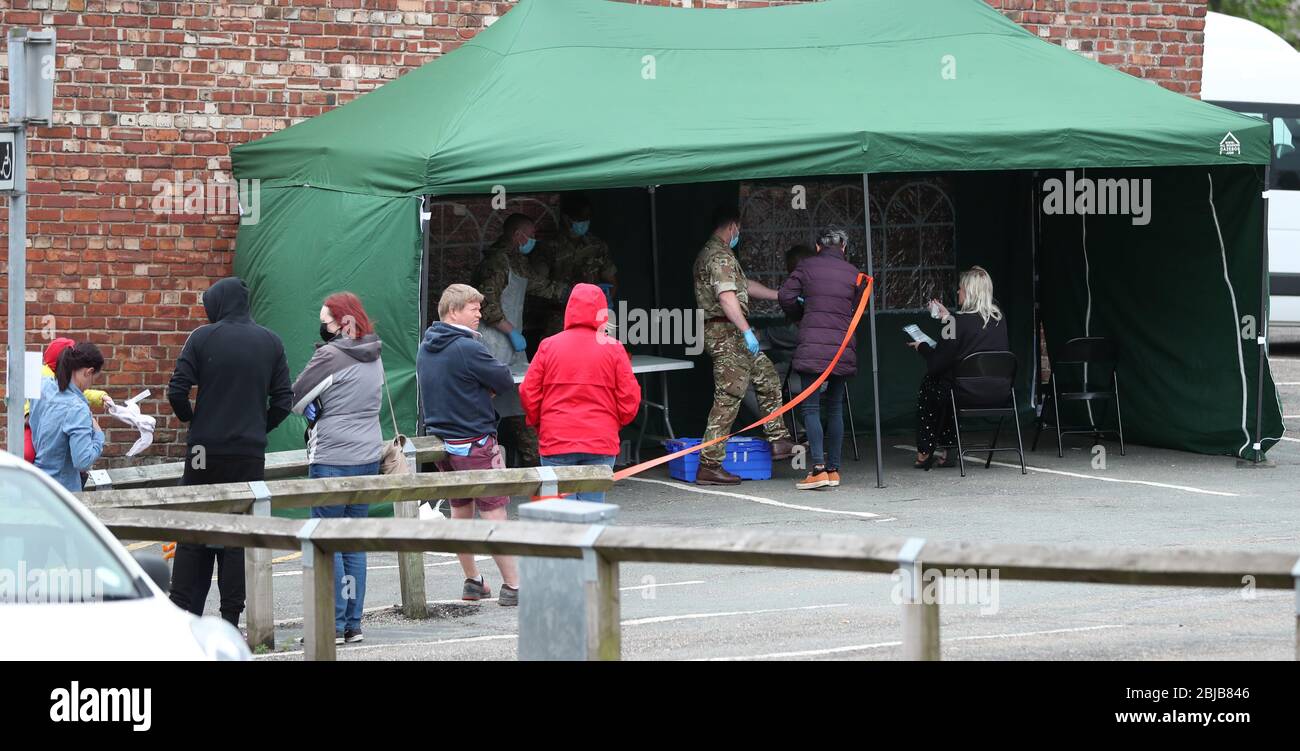 People queue at a walk-in coronavirus testing centre staffed by ...