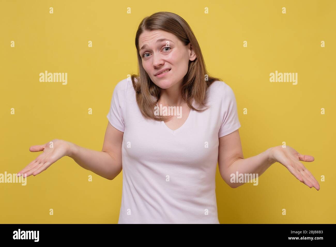 Shrugging pose hi-res stock photography and images - Alamy