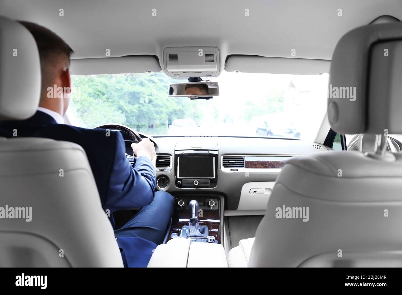 Man driving car, back view Stock Photo - Alamy