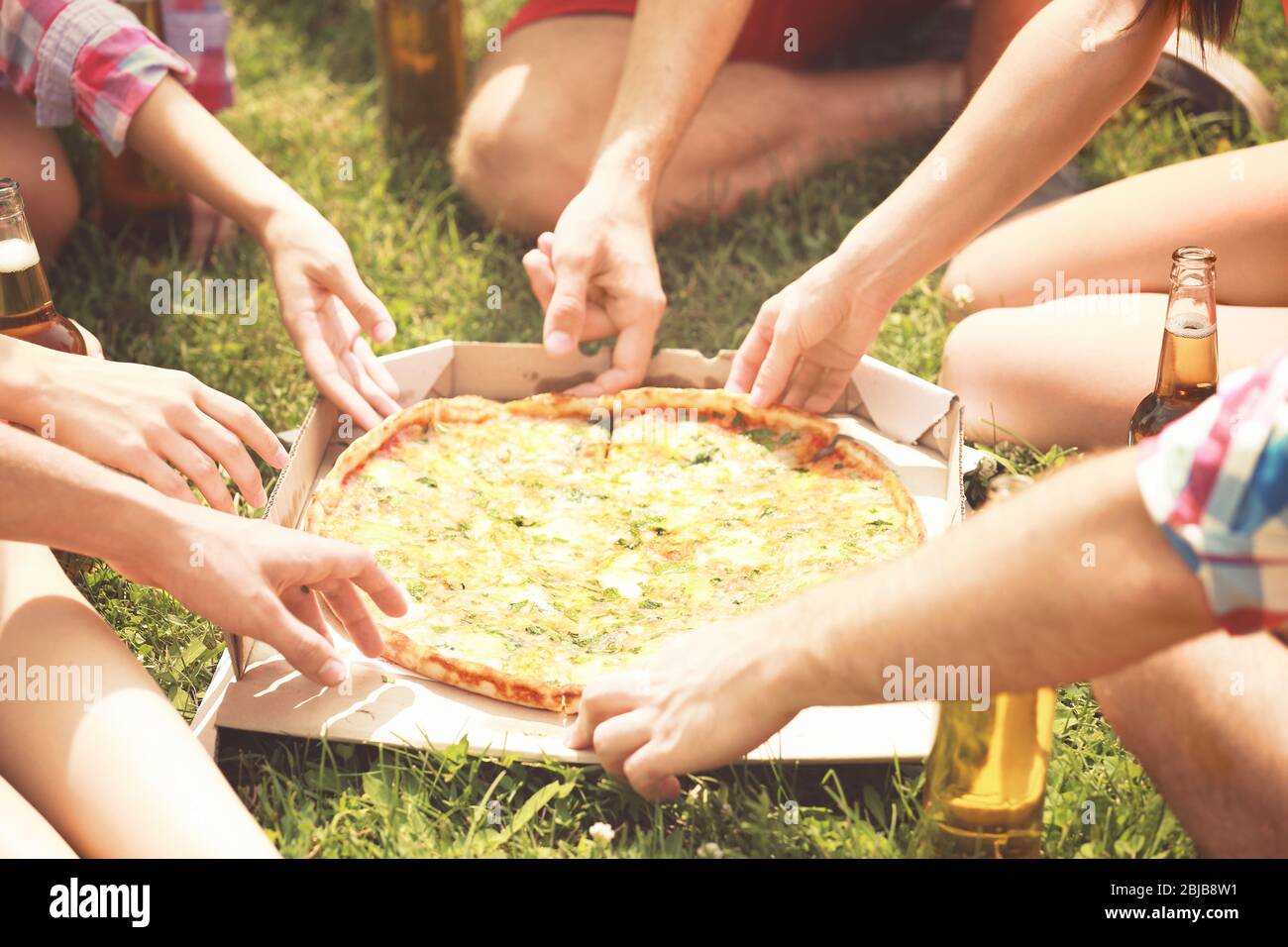 Hands take slices of pizza hi-res stock photography and images - Alamy