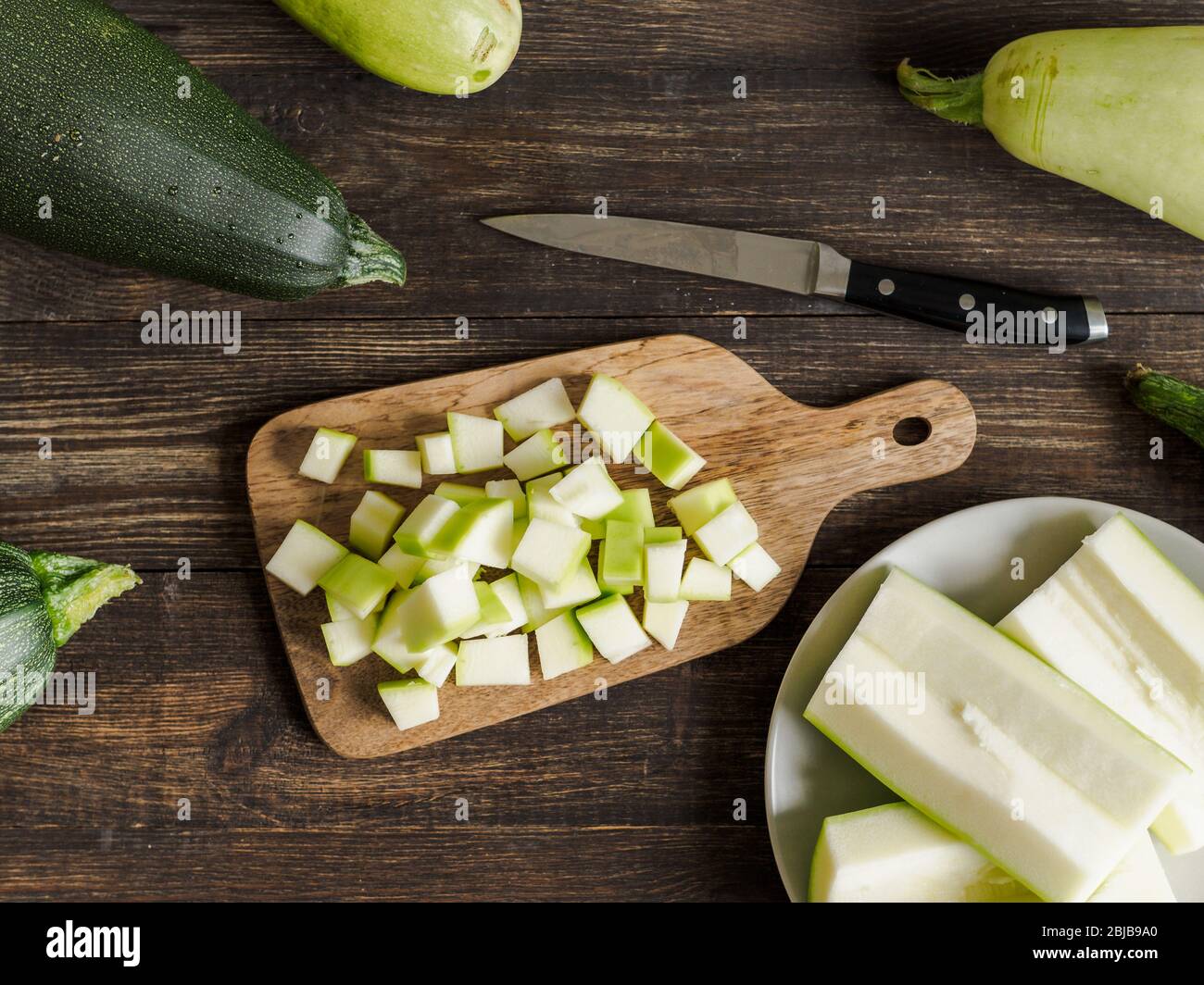 Zucchini harvest. Slices farm organic zucchini cubes for freezing on ...