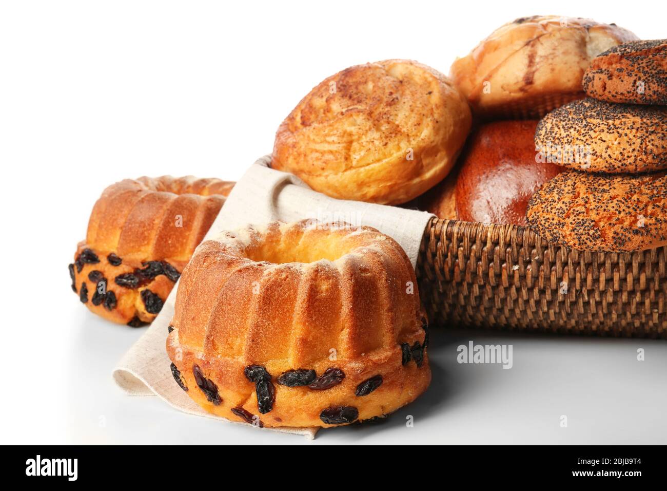 Assortment of fresh pastries with wicker bowl on white background Stock ...