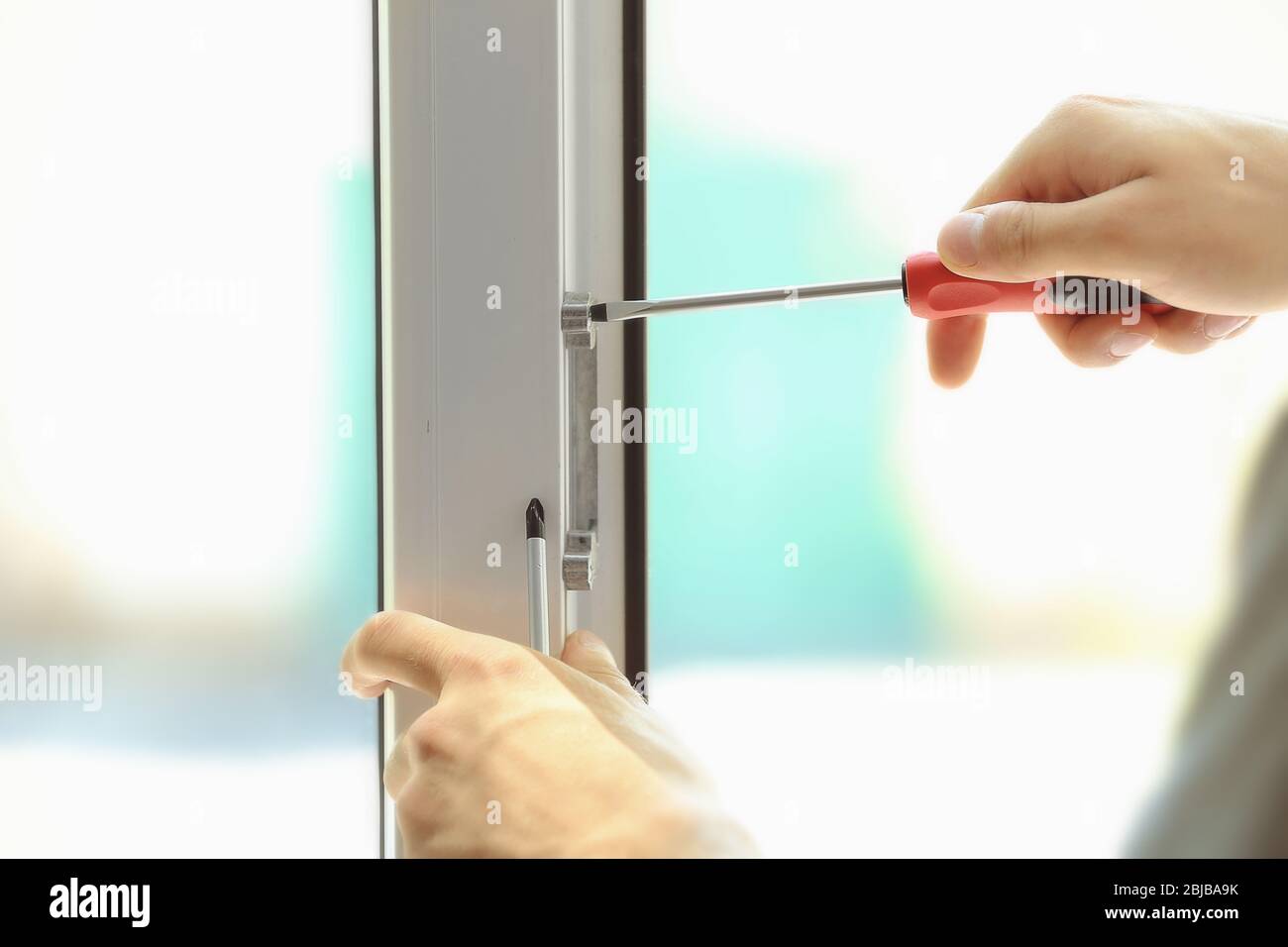 Construction worker installing window in house Stock Photo - Alamy