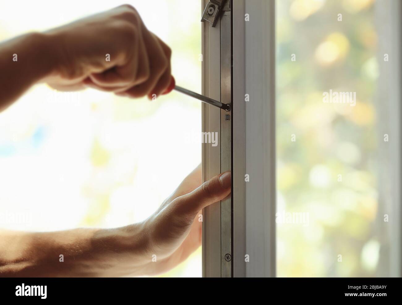 Construction worker installing window in house Stock Photo - Alamy