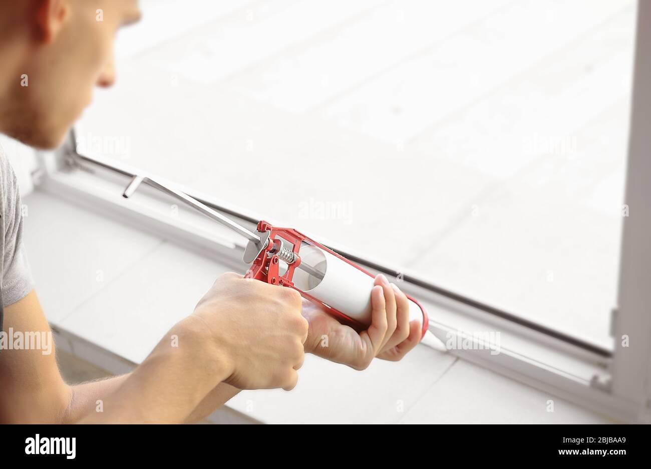 Construction worker installing window in house Stock Photo - Alamy
