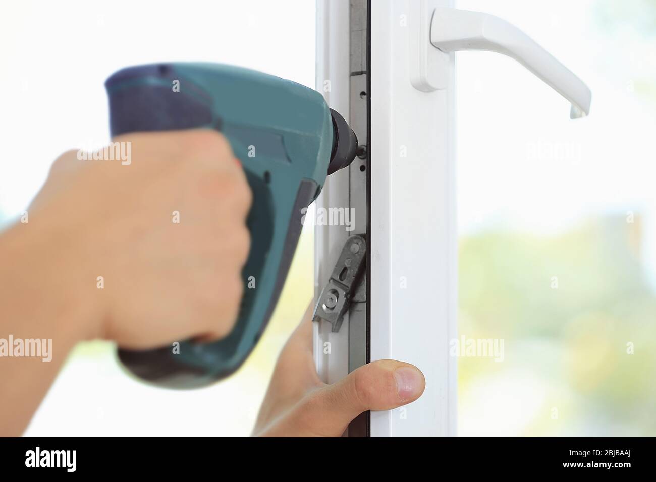 Construction worker installing window in house Stock Photo - Alamy