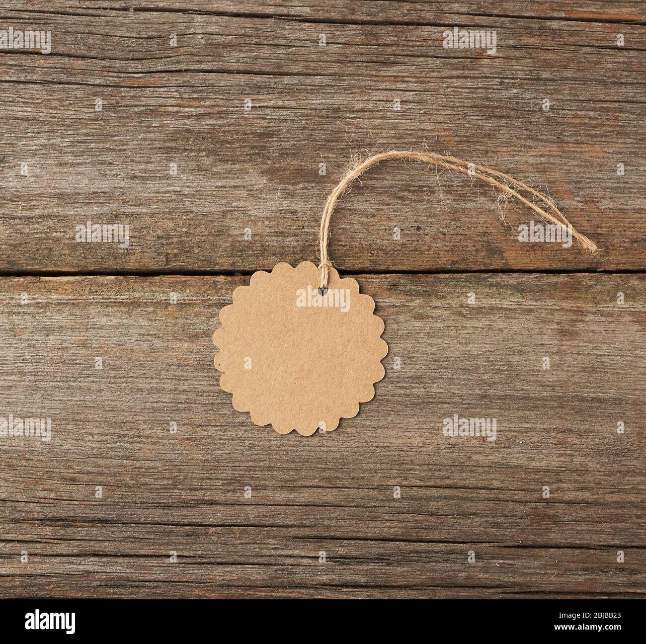 Round empty brown paper tag tied with white string. Price tag, gift tag ...