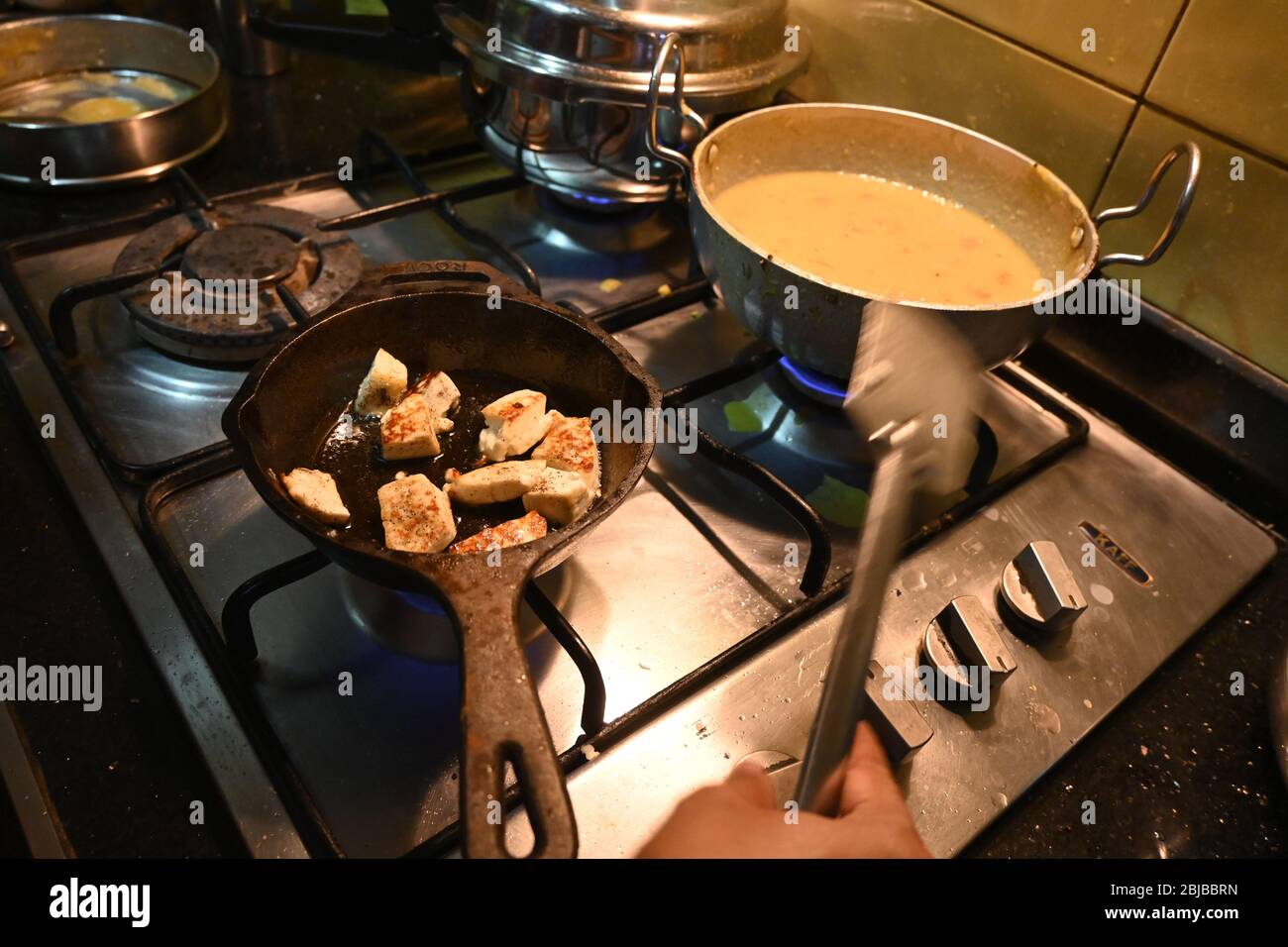 cooking on an iron skillet Stock Photo - Alamy
