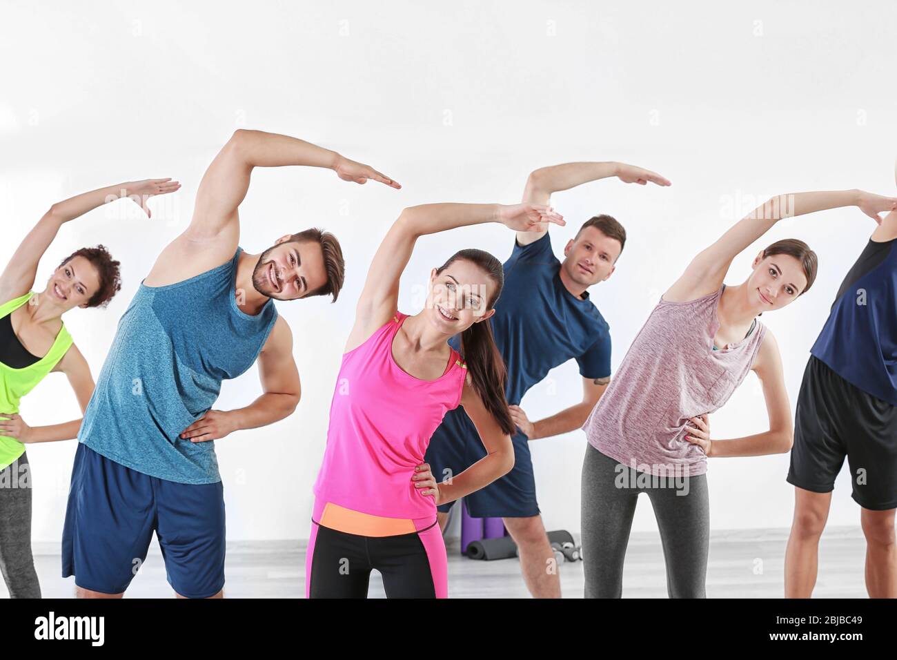 Group of people doing exercises in gym Stock Photo - Alamy