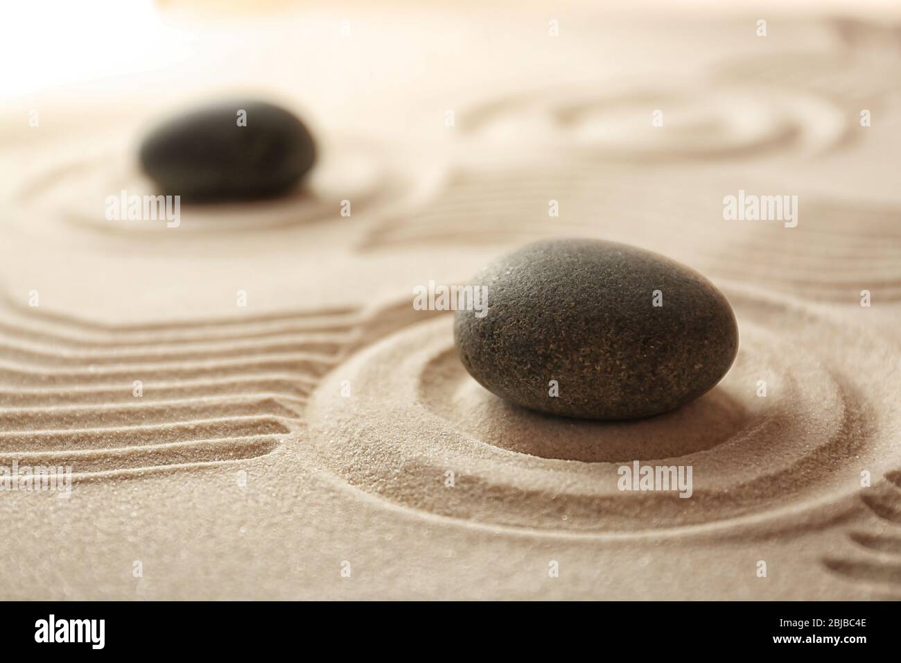 Japanese Zen garden. Pebbles on a sand Stock Photo - Alamy