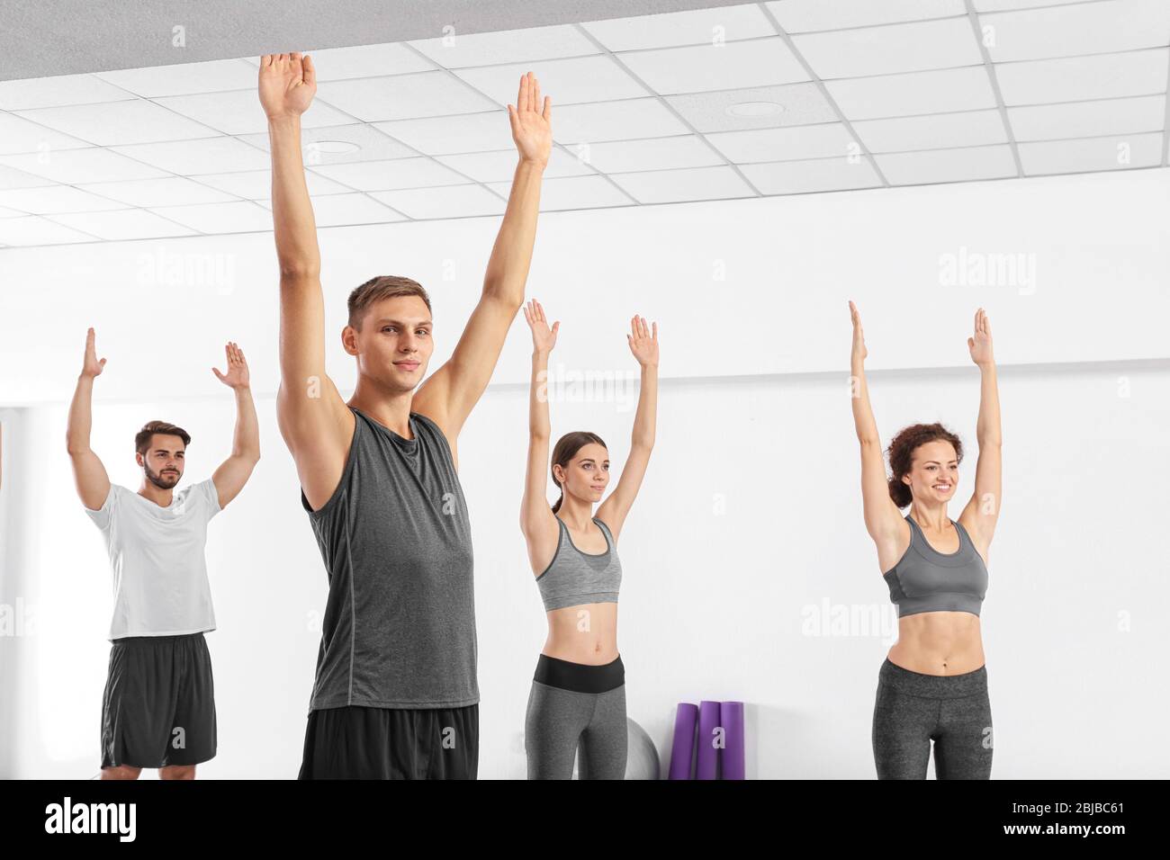 Group of people doing exercises in gym Stock Photo - Alamy