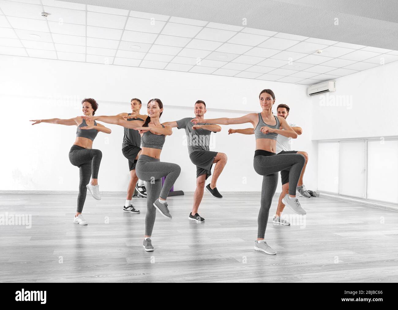 Group of people doing exercises in gym Stock Photo - Alamy