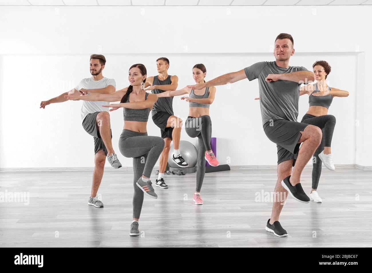 Group of people doing exercises in gym Stock Photo - Alamy