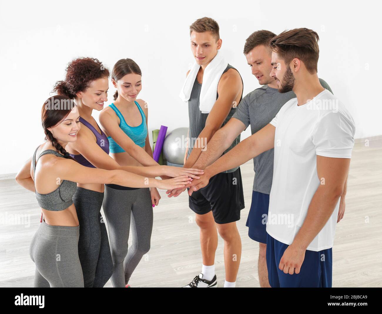 Team work concept. Group of people making pile of hands in gym Stock ...