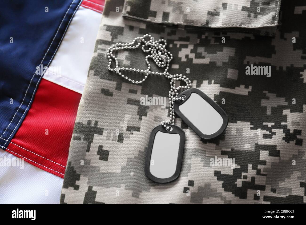 Army tokens on military uniform and USA national flag background Stock ...