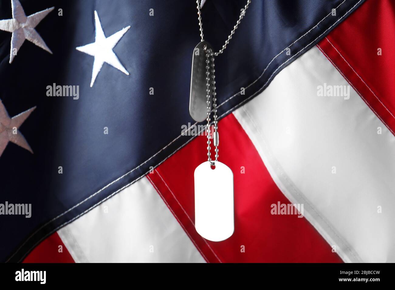 Army tokens on American national flag background Stock Photo - Alamy