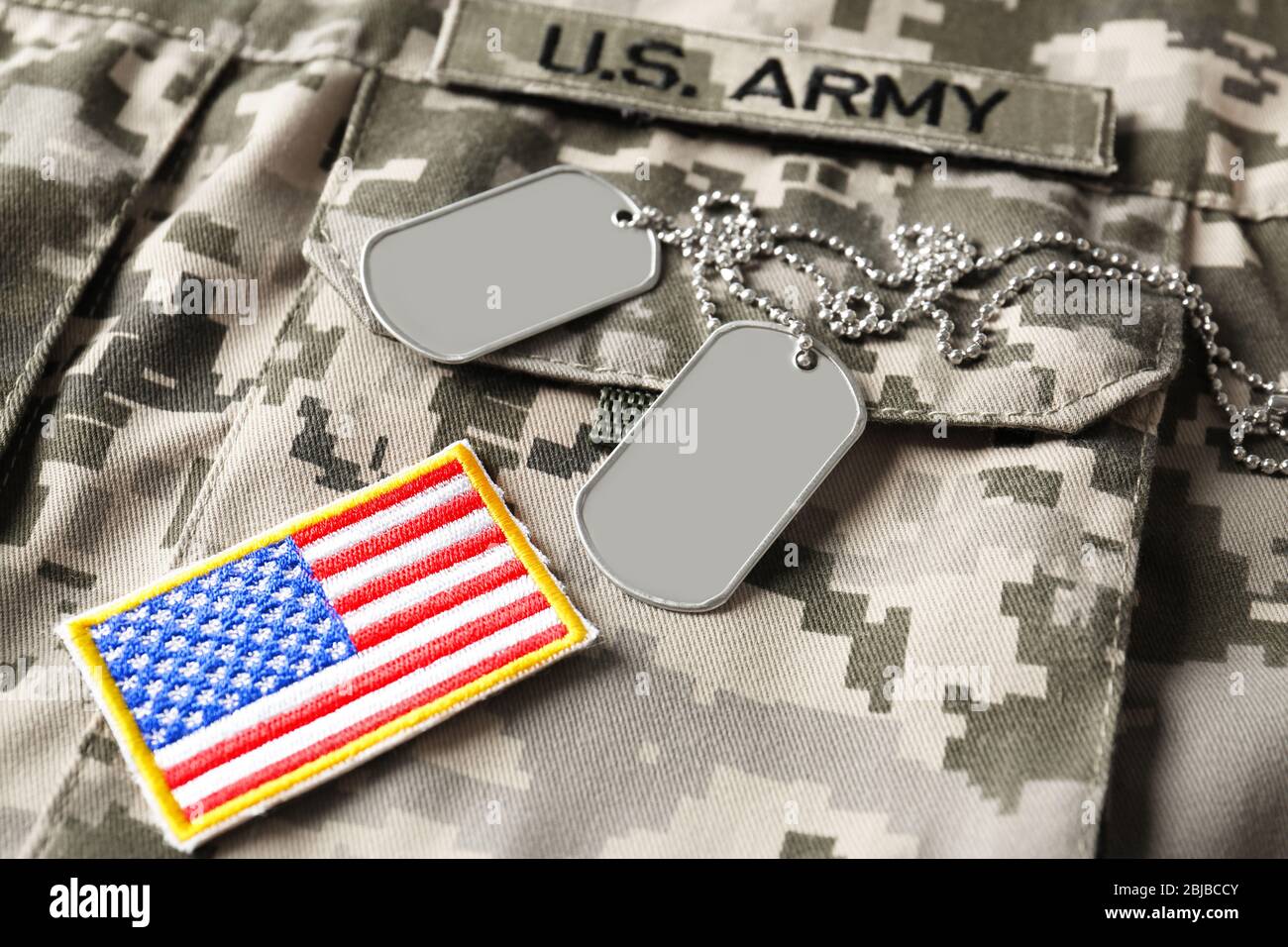 Army tokens and patches on military uniform background Stock Photo - Alamy