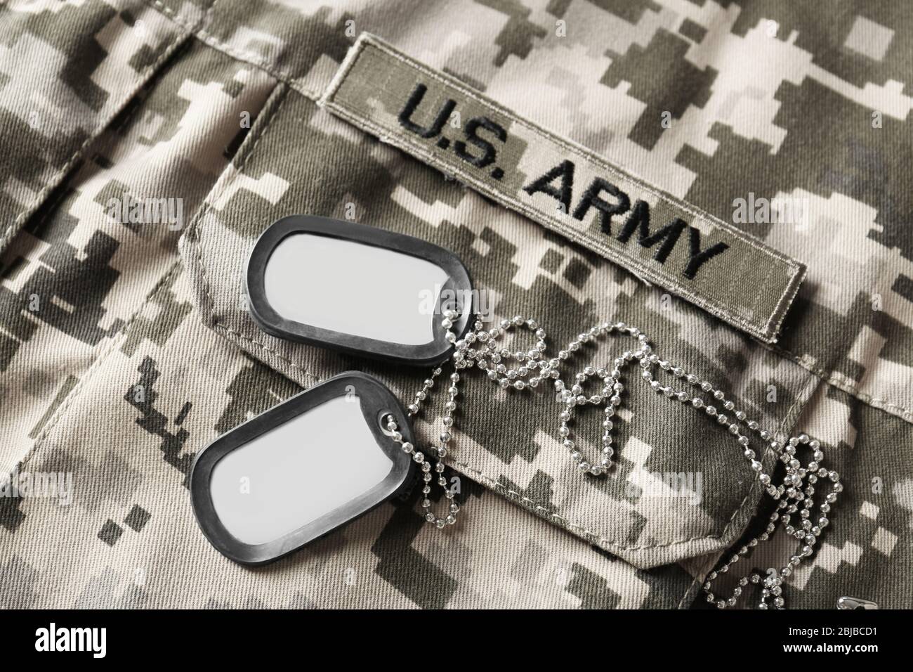 Army tokens and patch on military uniform background Stock Photo - Alamy