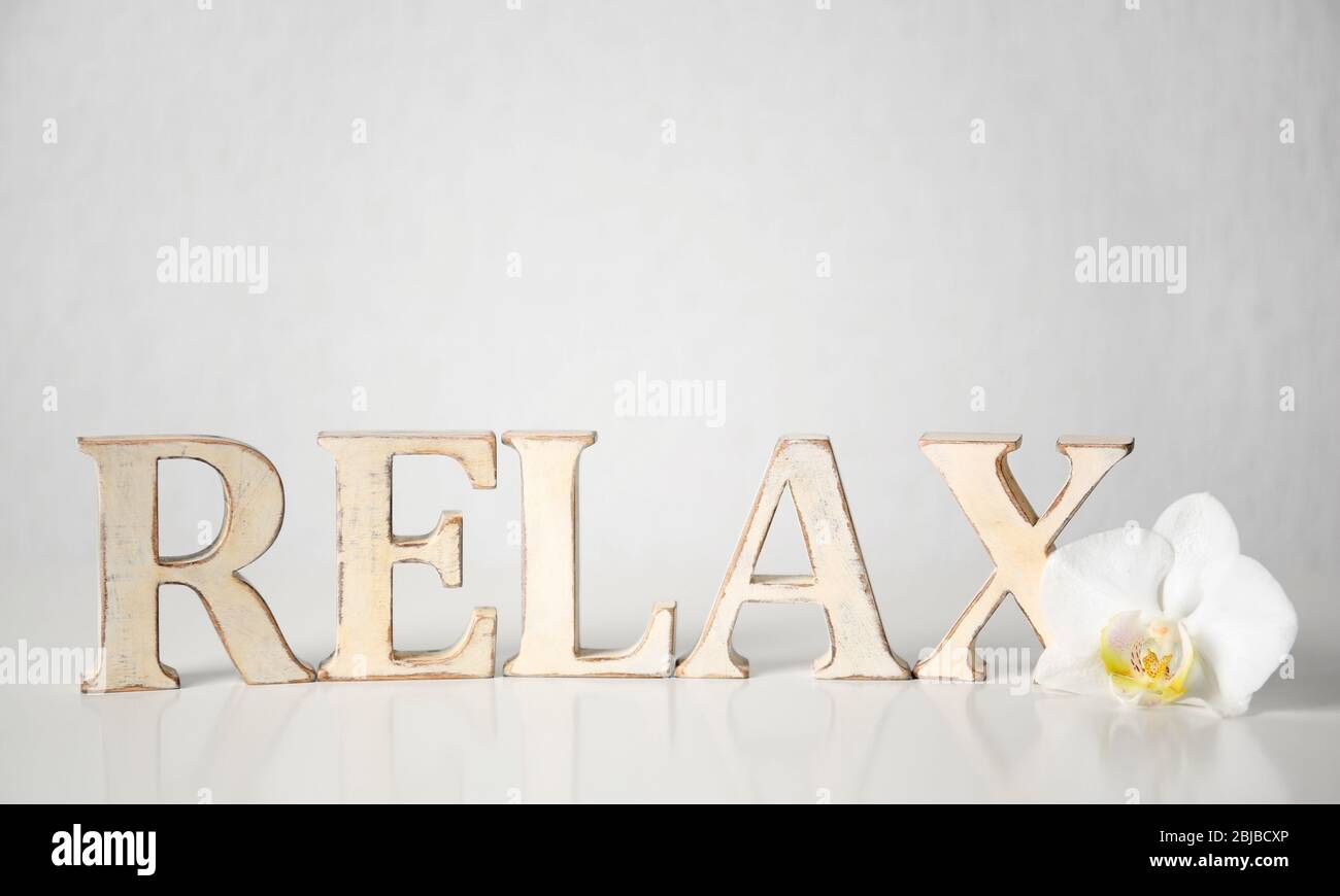 Relax word on wooden table hi-res stock photography and images - Alamy