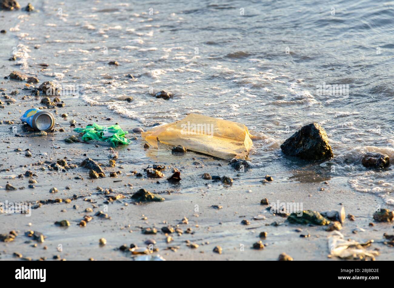 Rubbish near shoreline Stock Photo - Alamy