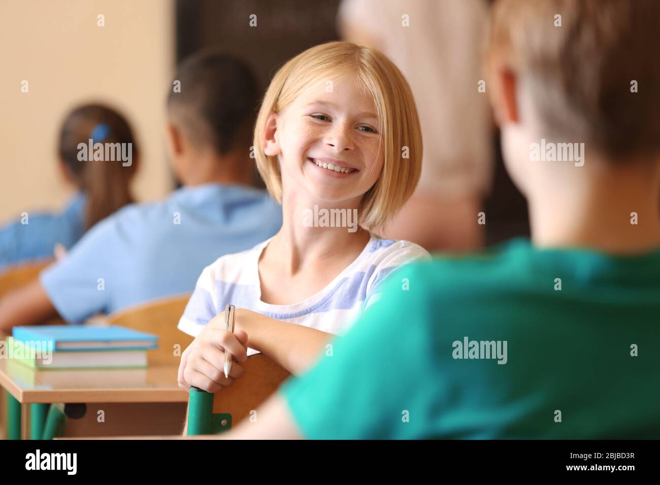 Cute schoolgirl on lesson in classroom Stock Photo - Alamy