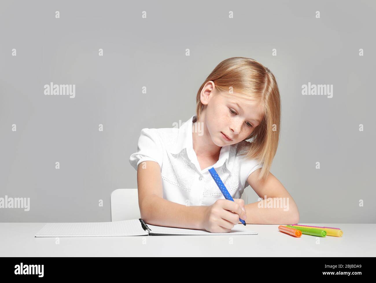 Cute girl making homework at home Stock Photo - Alamy