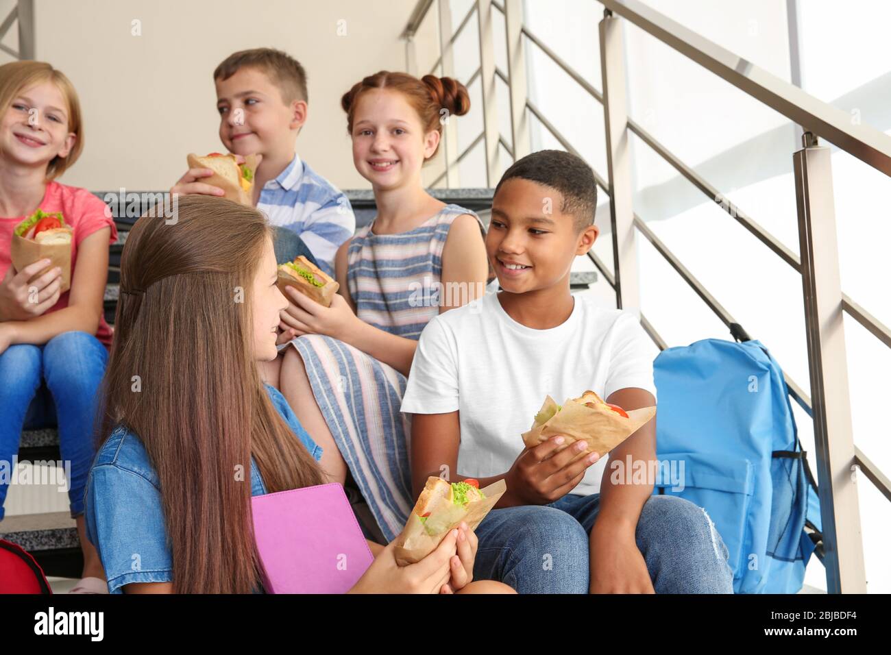 Children sitting on steps eating hi-res stock photography and images ...