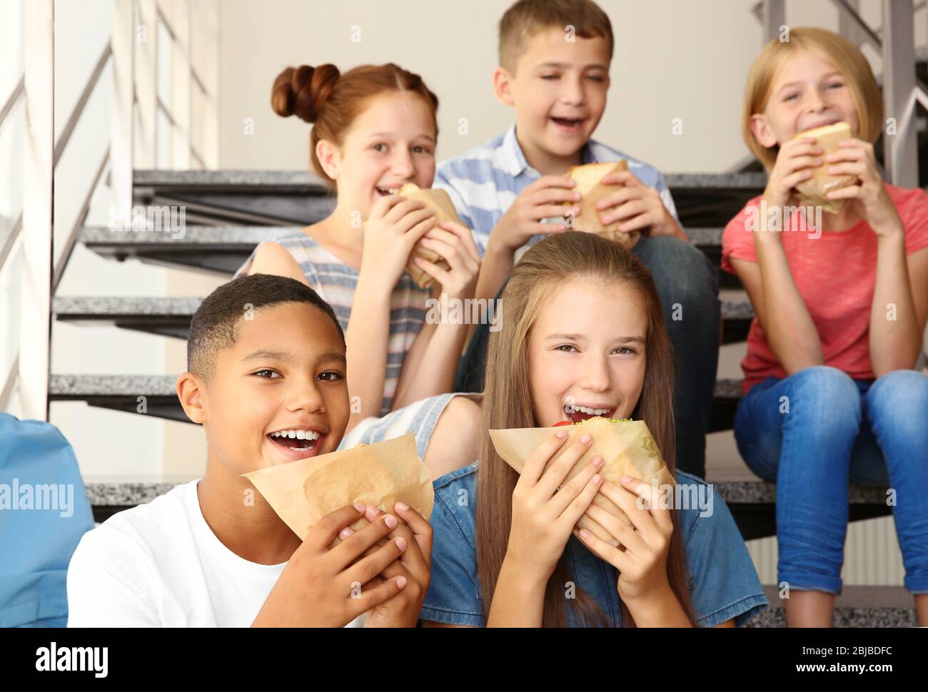 Children sitting on steps eating hi-res stock photography and images ...