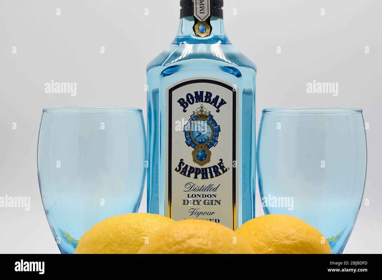 Bottle of Bombay Sapphire gin with two goblets and lemons white ...