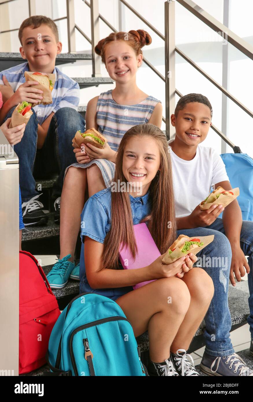 Children sitting on steps eating hi-res stock photography and images ...