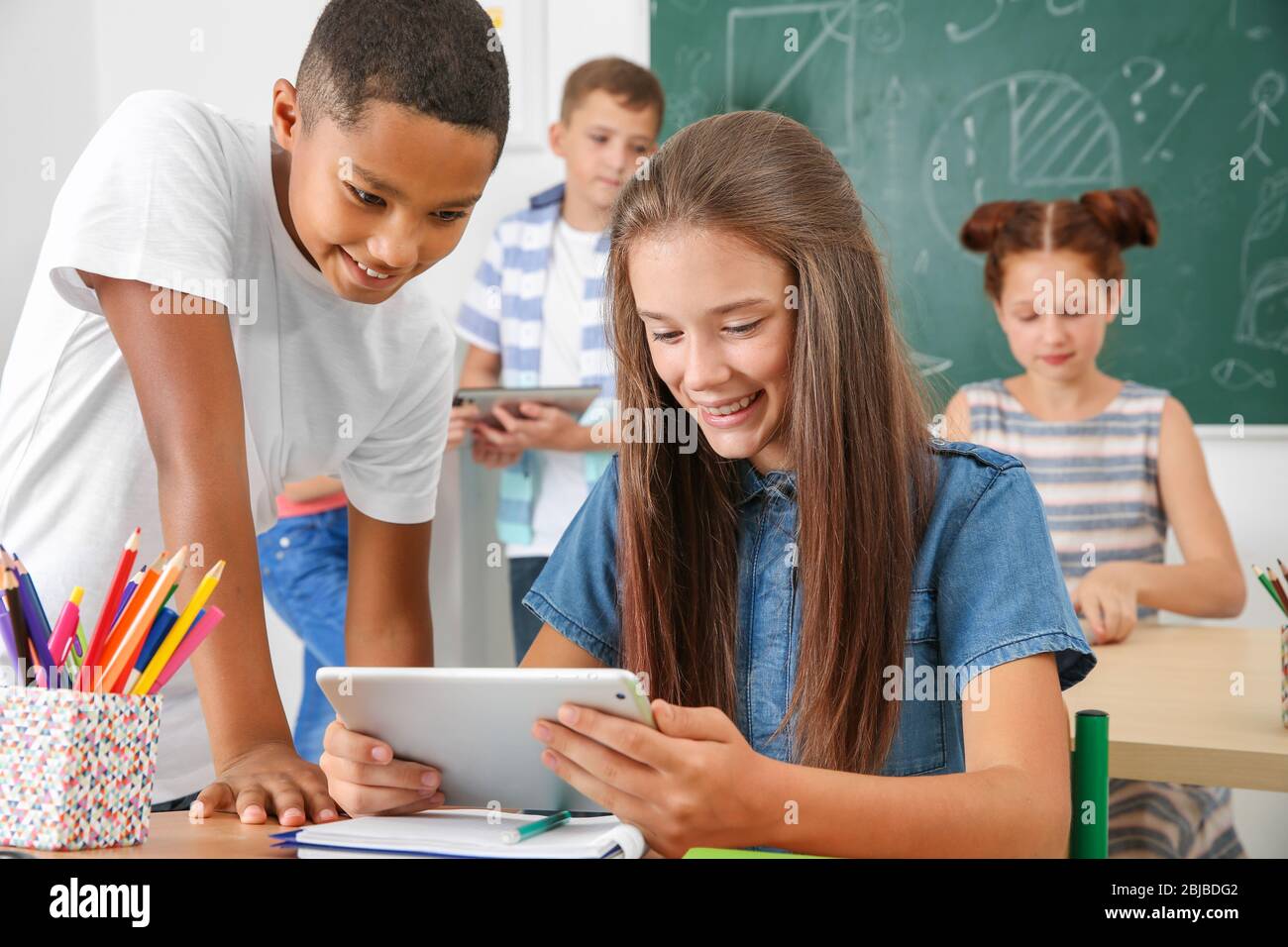 Boy girl class tablet pencil hi-res stock photography and images - Alamy