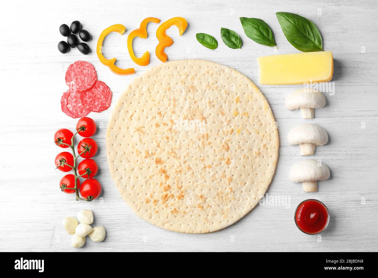 Raw pizza ingredients on wooden background, top view Stock Photo - Alamy