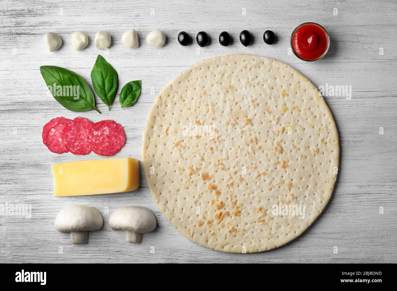 Raw pizza ingredients on wooden background, top view Stock Photo - Alamy