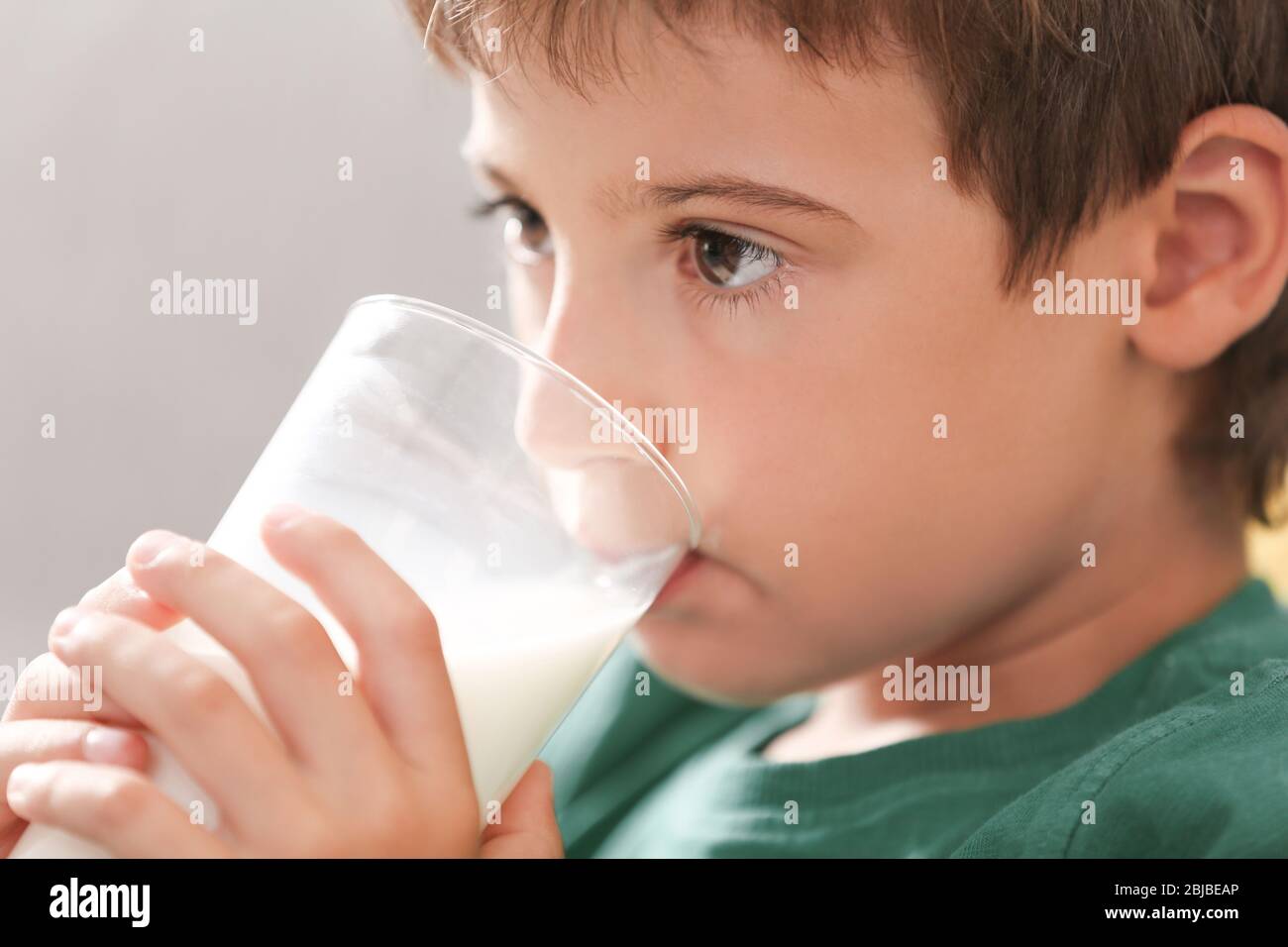 Portrait of cute kid drinking milk, closeup Stock Photo - Alamy